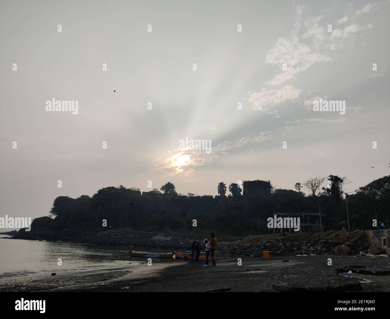 a beautiful sunset with sunrays on big broken old fort or palace ...