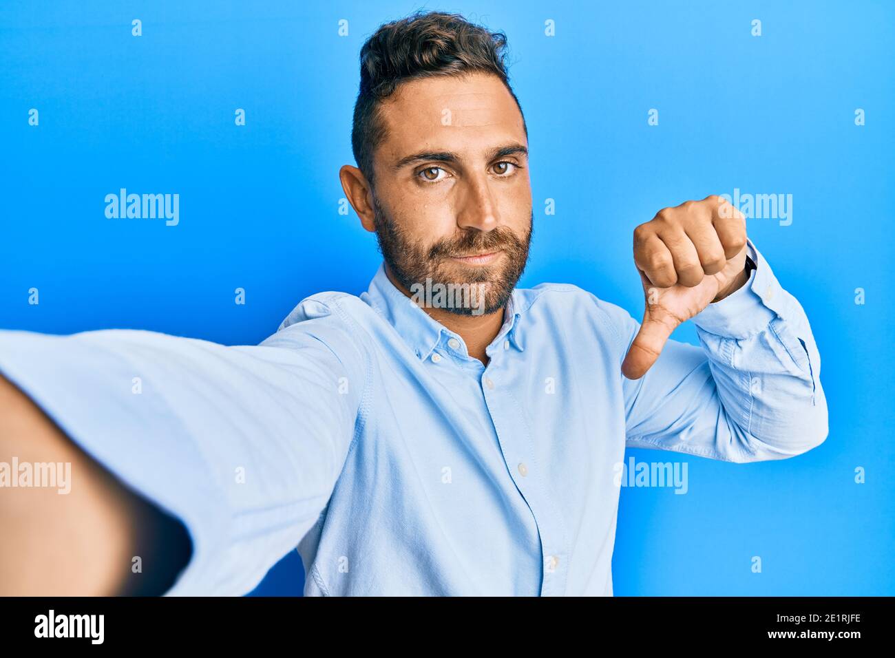 Handsome man with beard taking a selfie photo with smartphone with ...