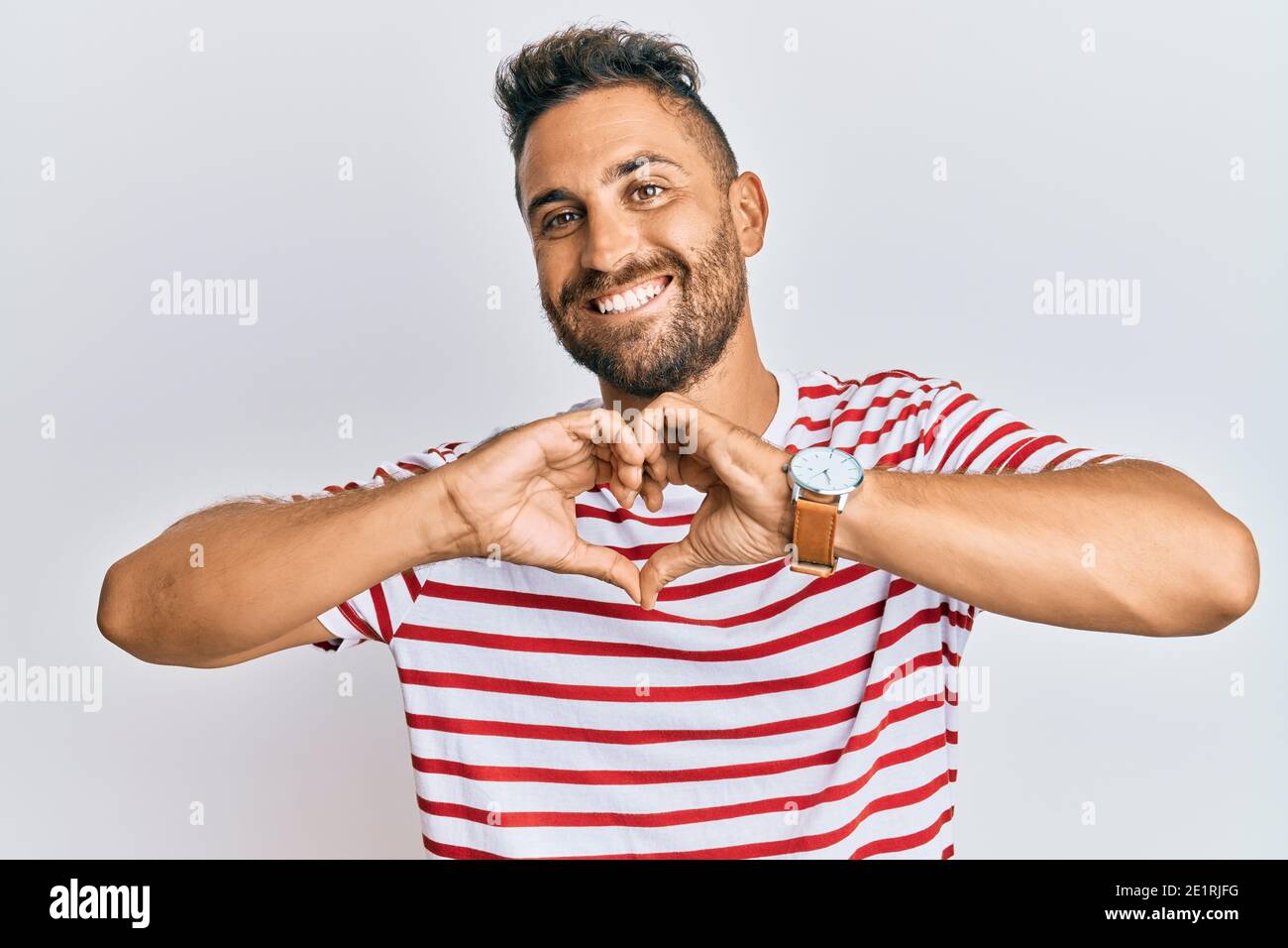 Handsome man with beard wearing casual clothes smiling in love showing ...