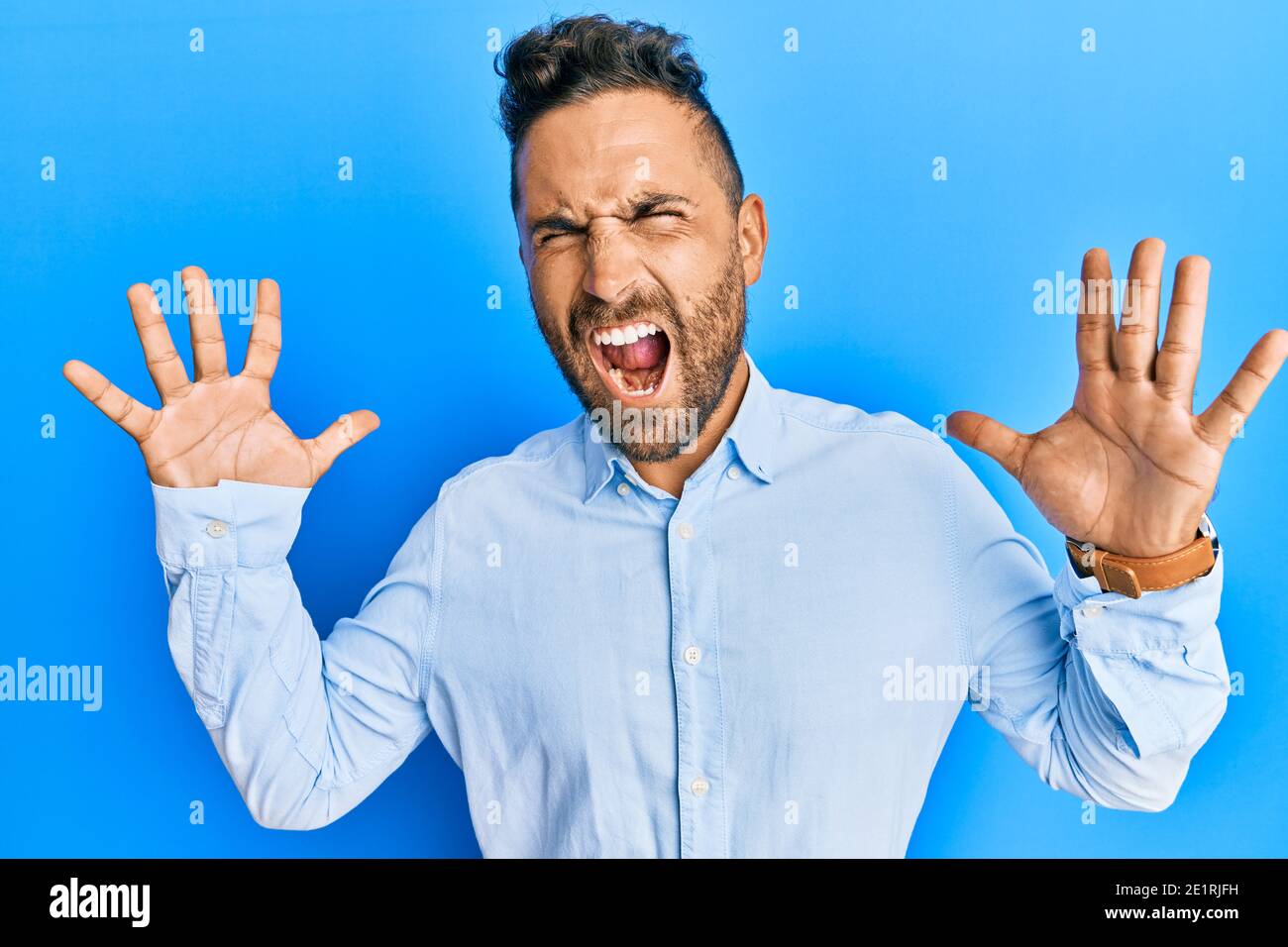 Handsome man with beard wearing casual clothes celebrating mad and ...