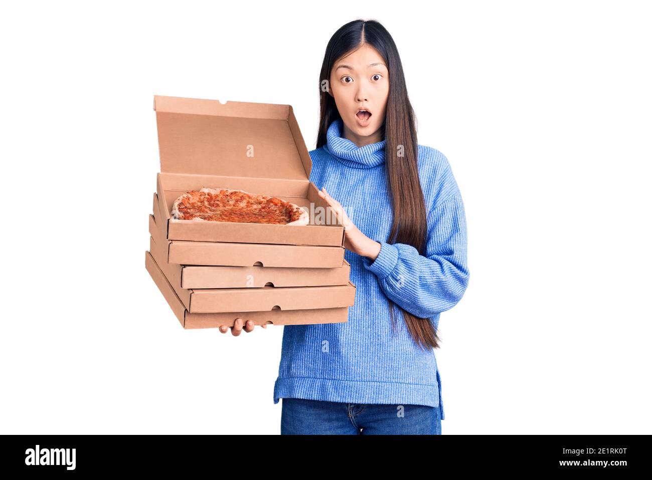 Young beautiful chinese woman holding cardboard boxes of italian pizza ...