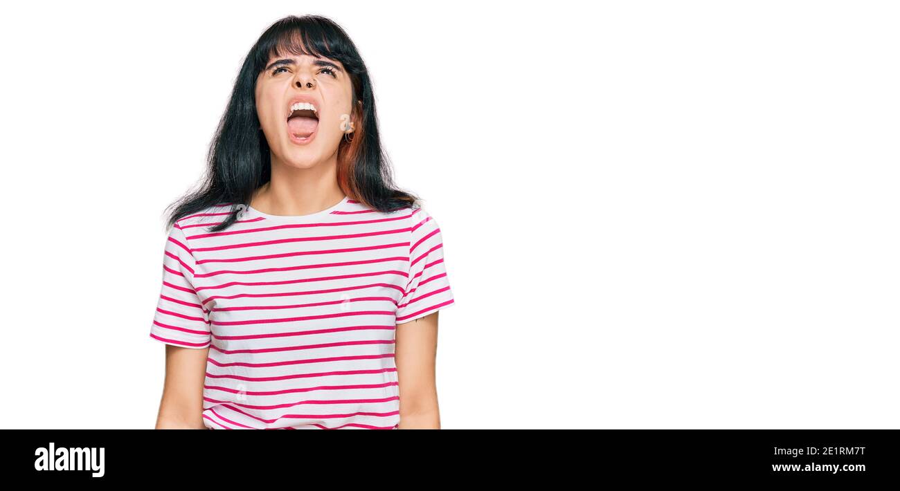 Young hispanic girl wearing casual clothes angry and mad screaming ...