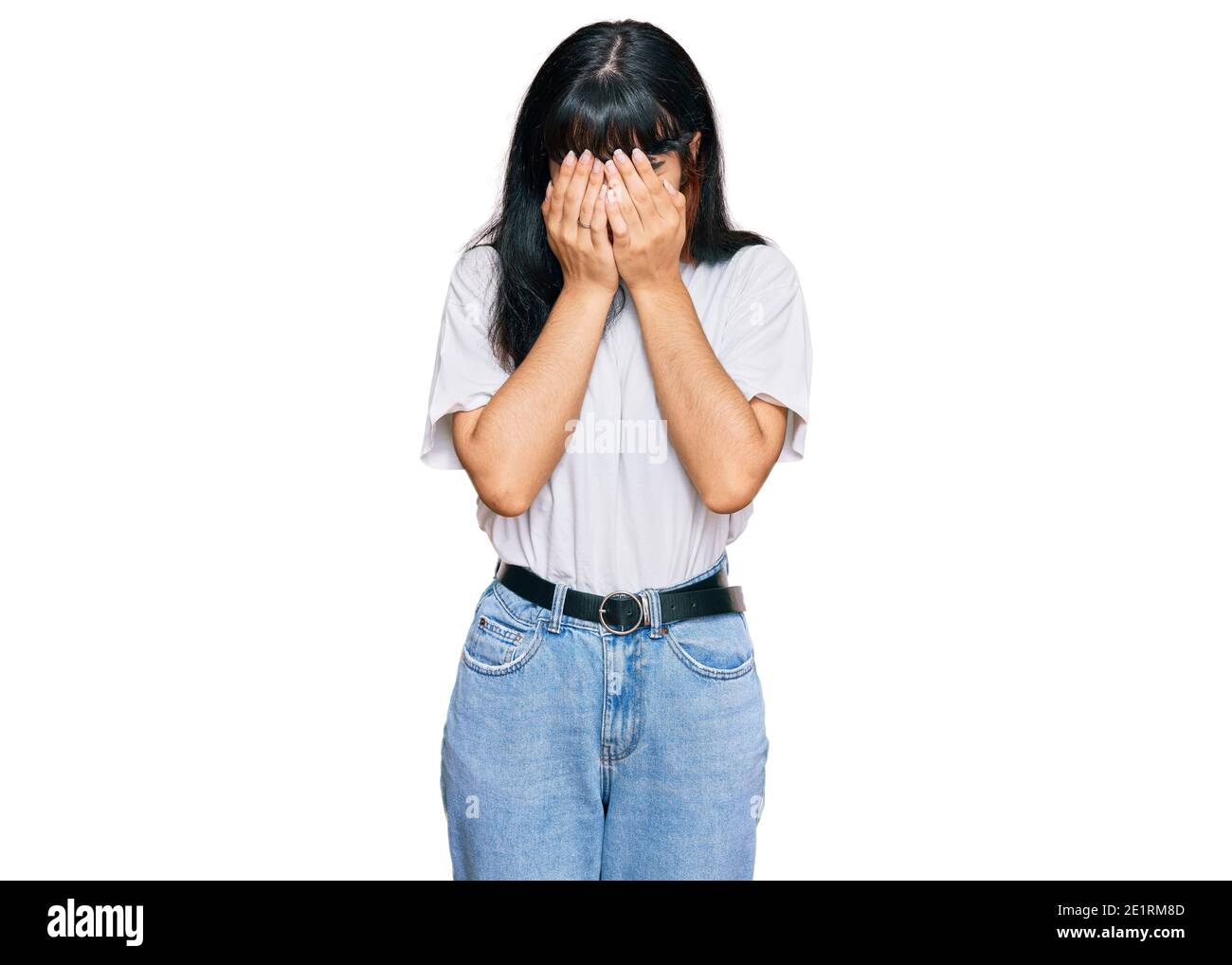 Young hispanic girl wearing casual clothes with sad expression covering ...