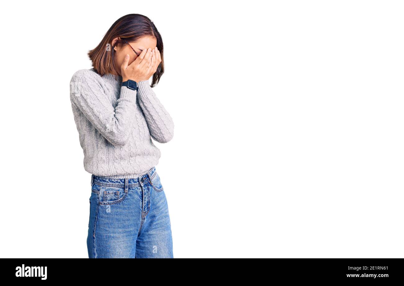 Young beautiful chinese girl wearing casual clothes with sad expression ...