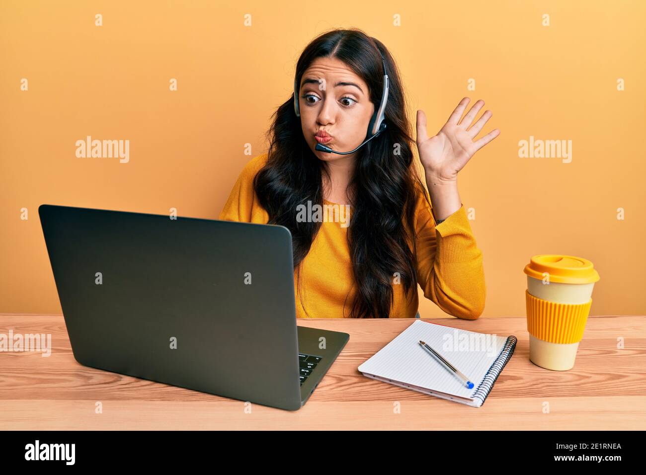 Beautiful brunette young woman wearing call center agent headset ...