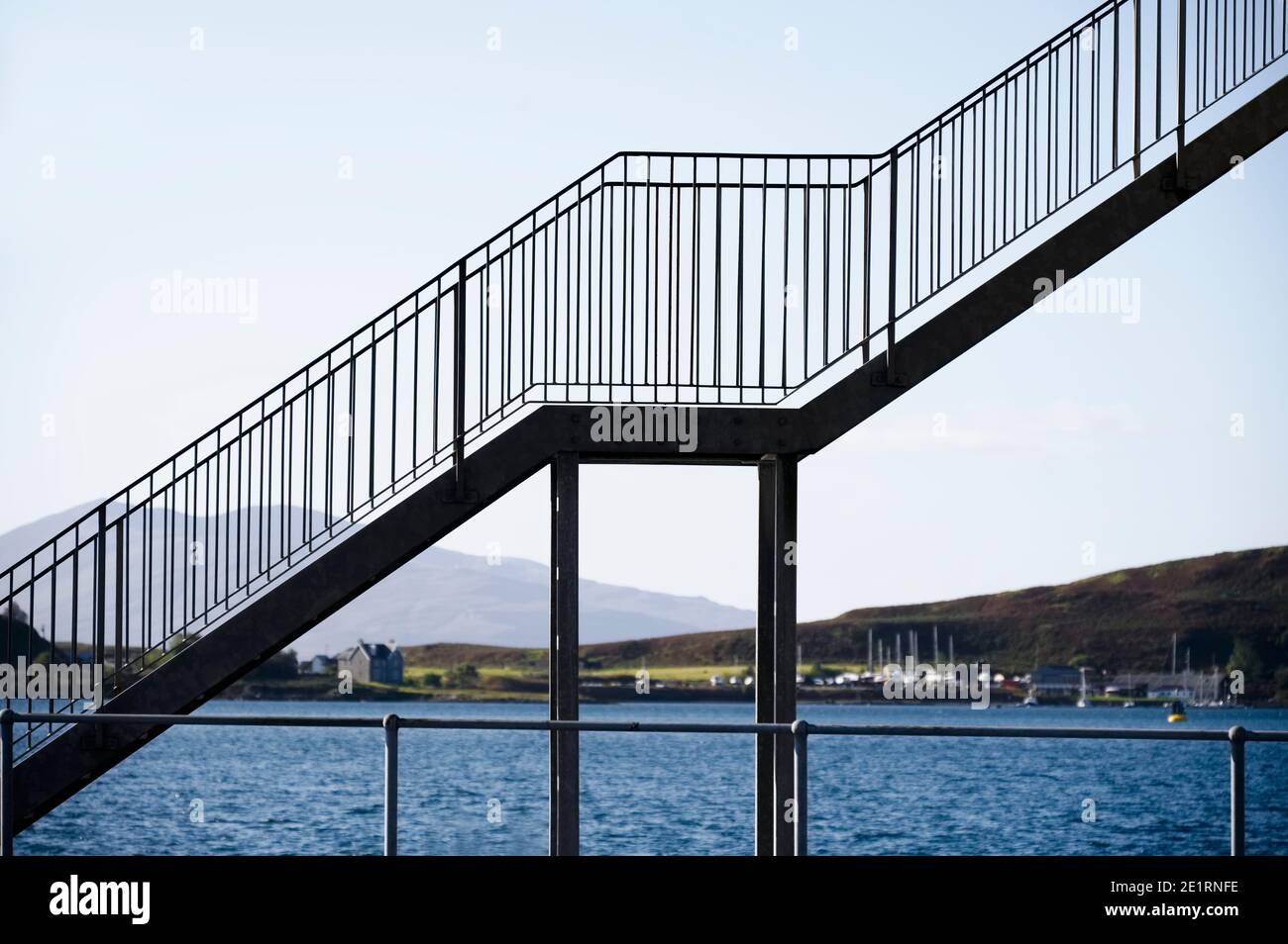 Metal stair silhouette and rail diagonal rising upwards at ferry port ...