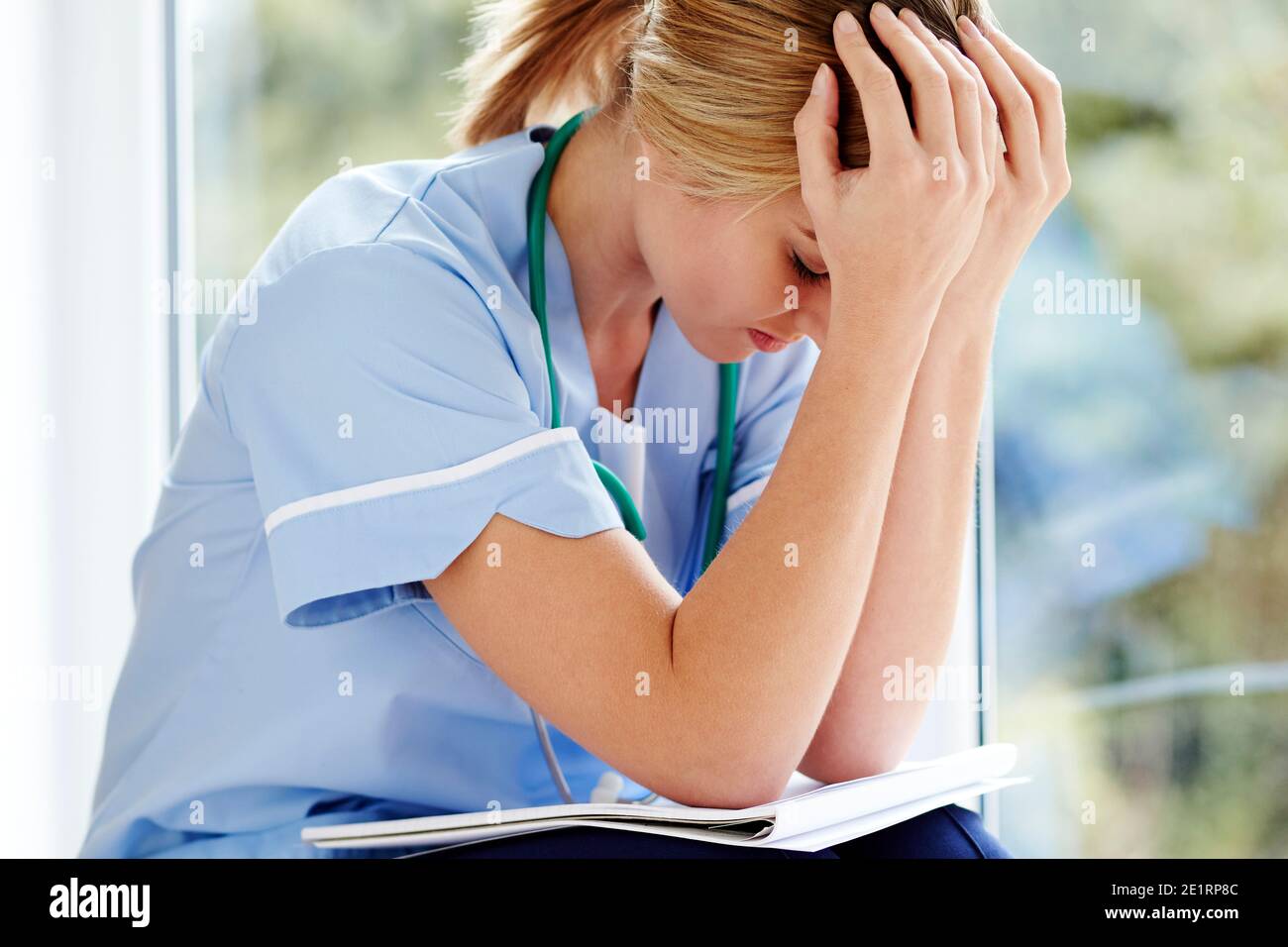 Tired nurse at work Stock Photo - Alamy