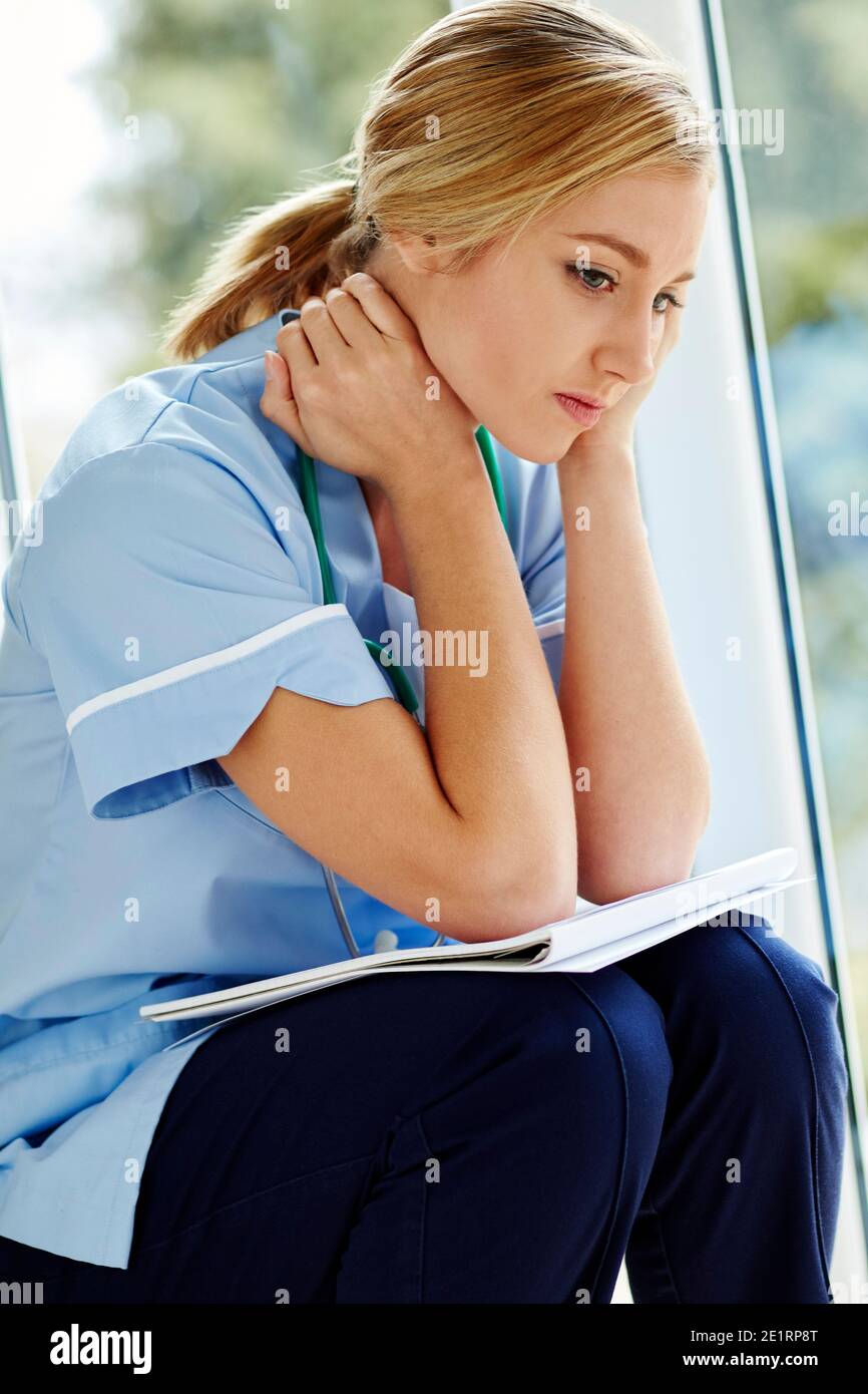 Tired nurse at work Stock Photo - Alamy