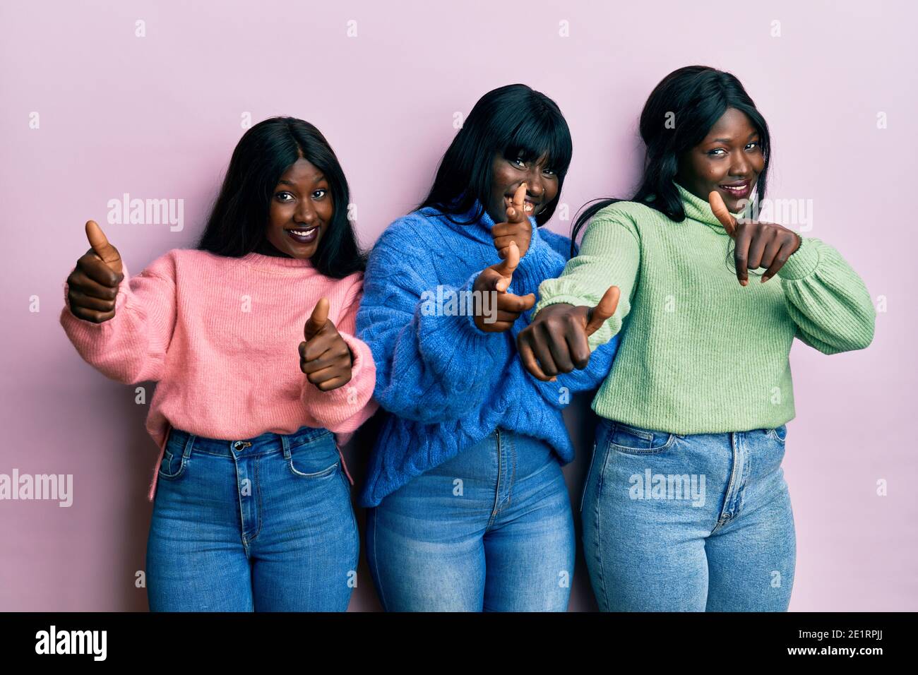 Three young african american friends wearing wool winter sweater ...
