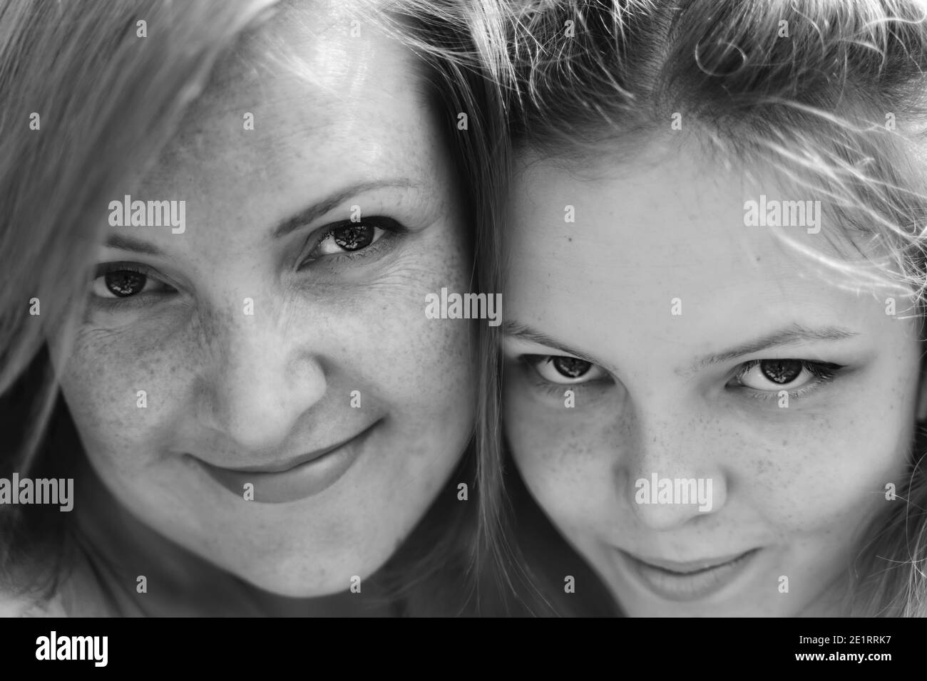 black and white portrait of mother and adult daughter close-up. similar ...