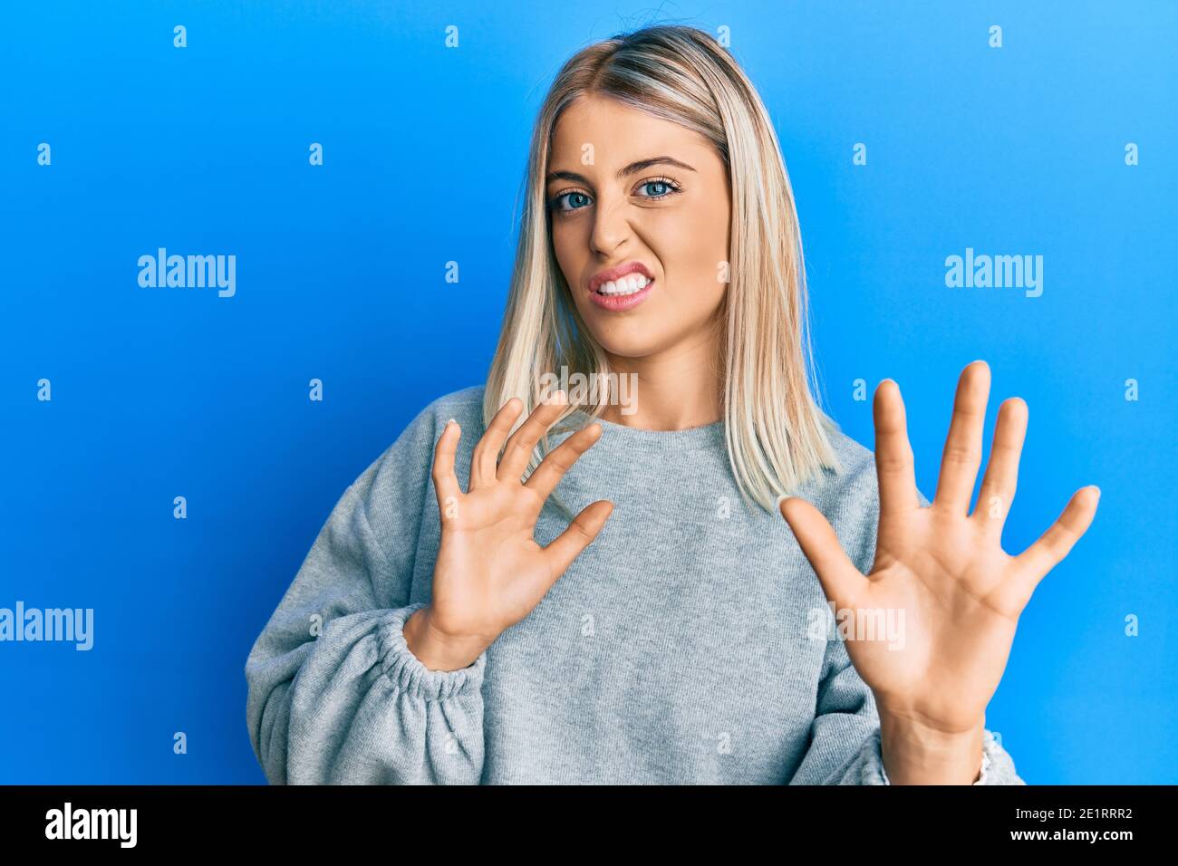 Beautiful blonde woman wearing casual clothes disgusted expression ...