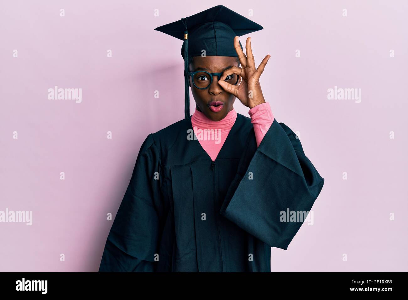Young african american girl wearing graduation cap and ceremony robe ...