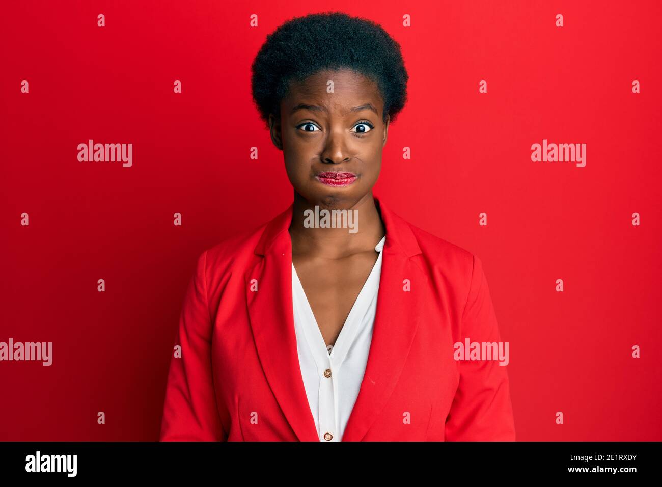 Young african american girl wearing business clothes puffing cheeks ...