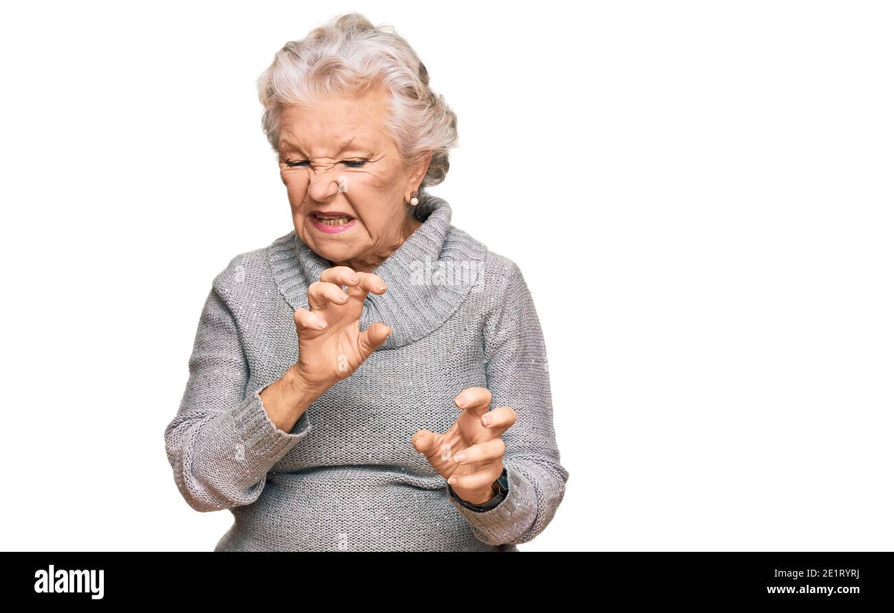 Senior grey-haired woman wearing casual winter sweater disgusted ...