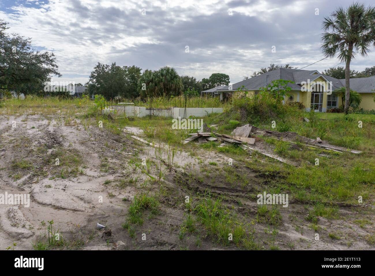 Tropical construction site overgrown and abandoned Stock Photo - Alamy