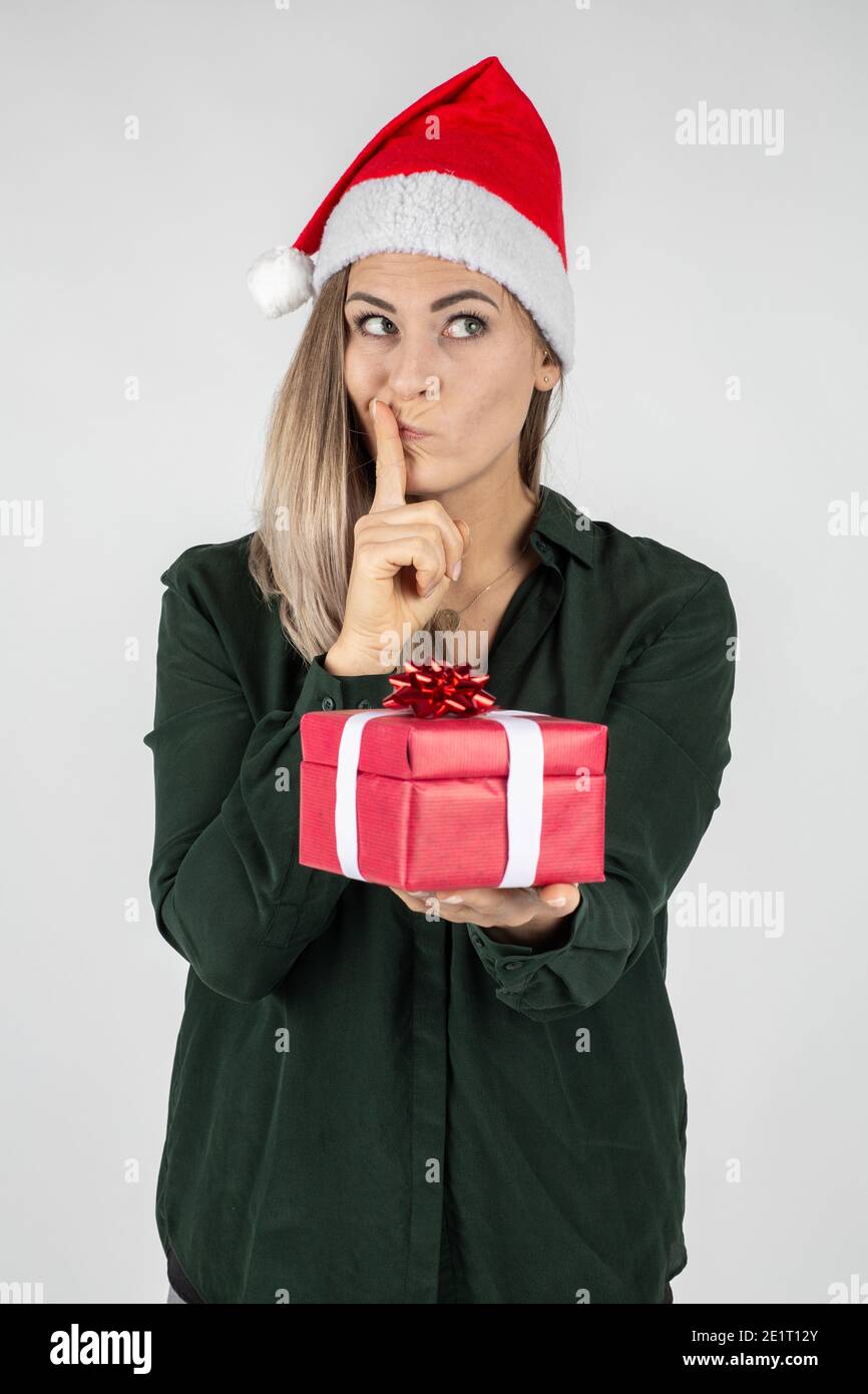 girl with Santa hat and red gift is disappointed and looking sad Stock ...