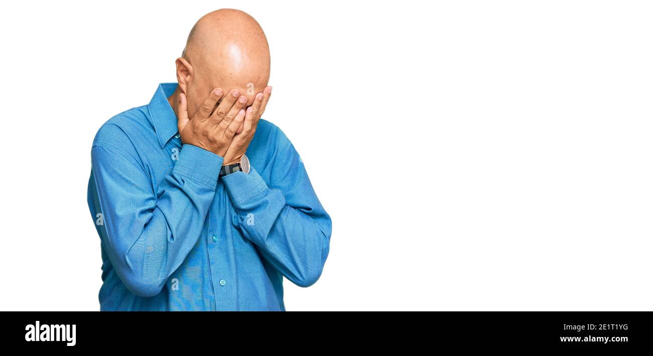 Middle age bald man wearing casual clothes with sad expression covering ...