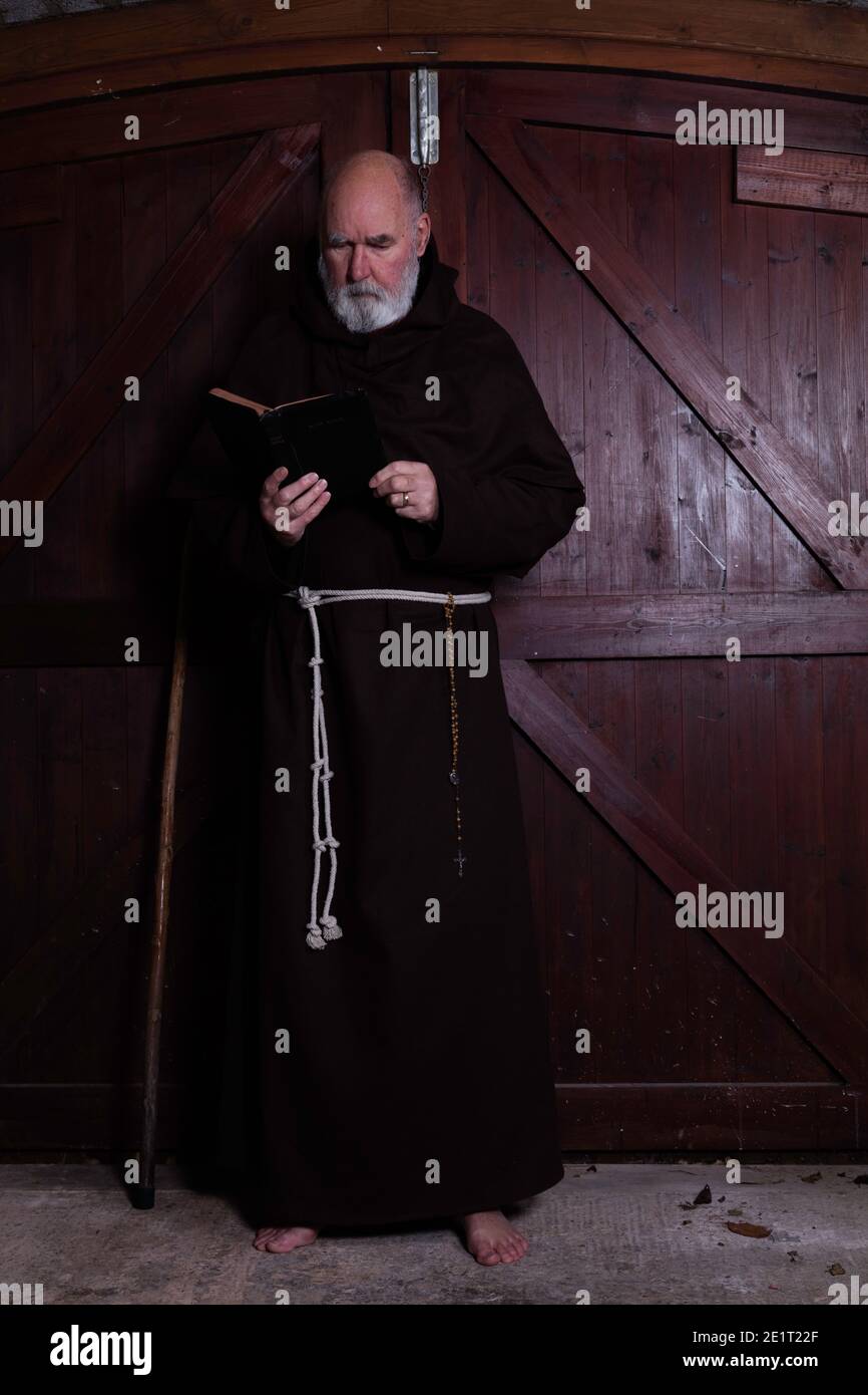 Franciscan monk, barefooted, reading his bible Stock Photo - Alamy