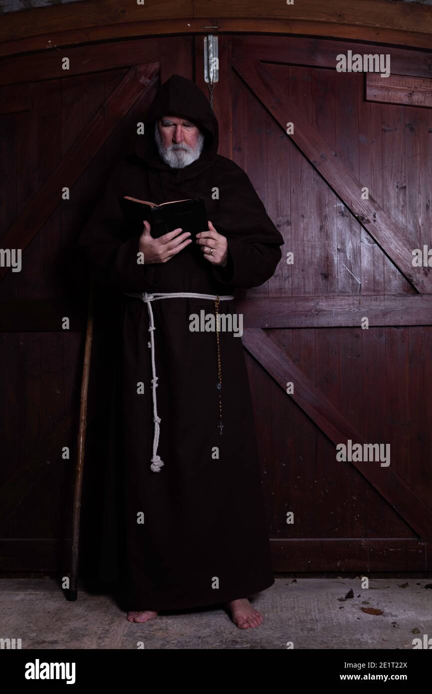 Franciscan monk, barefooted, reading his bible Stock Photo - Alamy