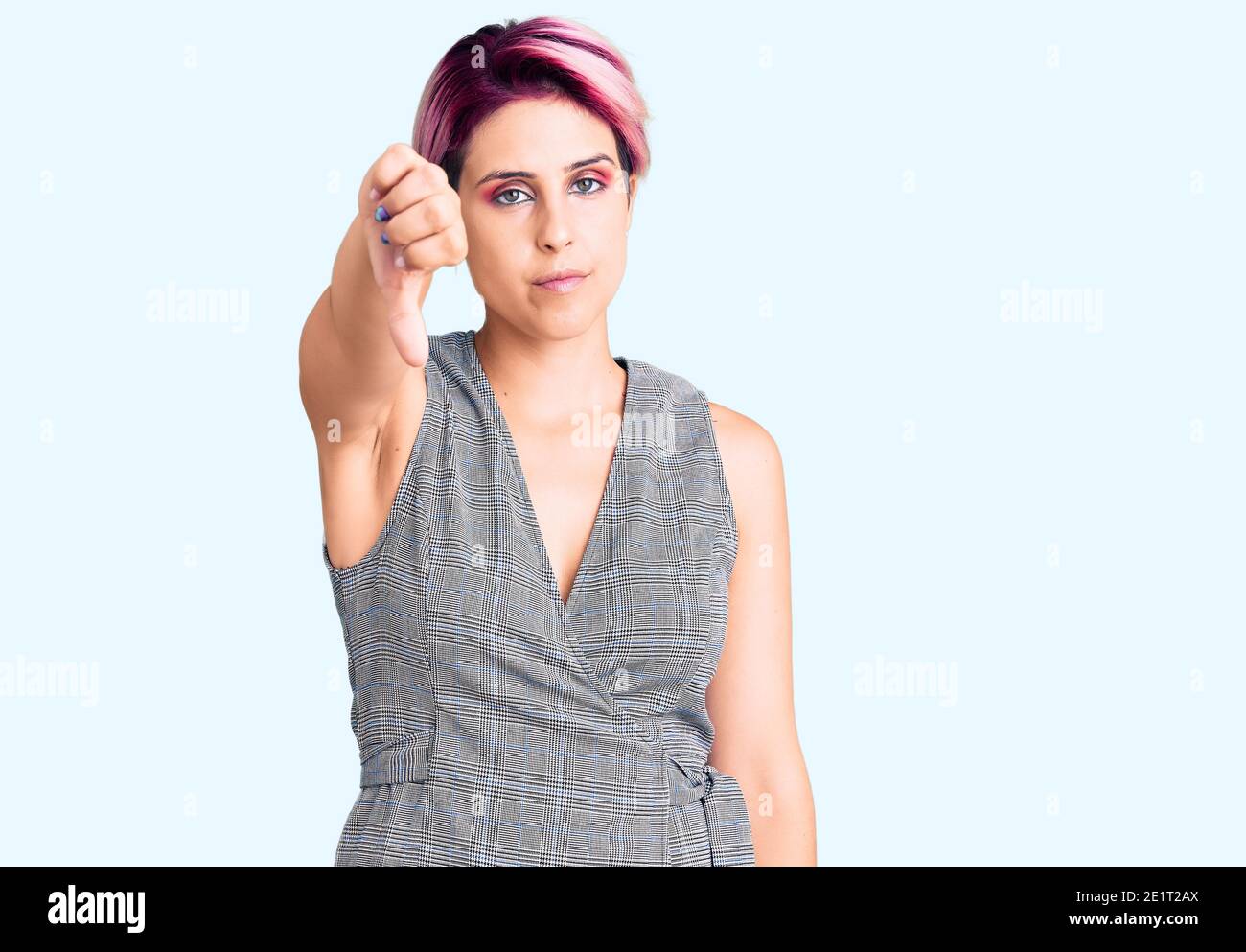 Young beautiful woman with pink hair wearing casual clothes looking ...