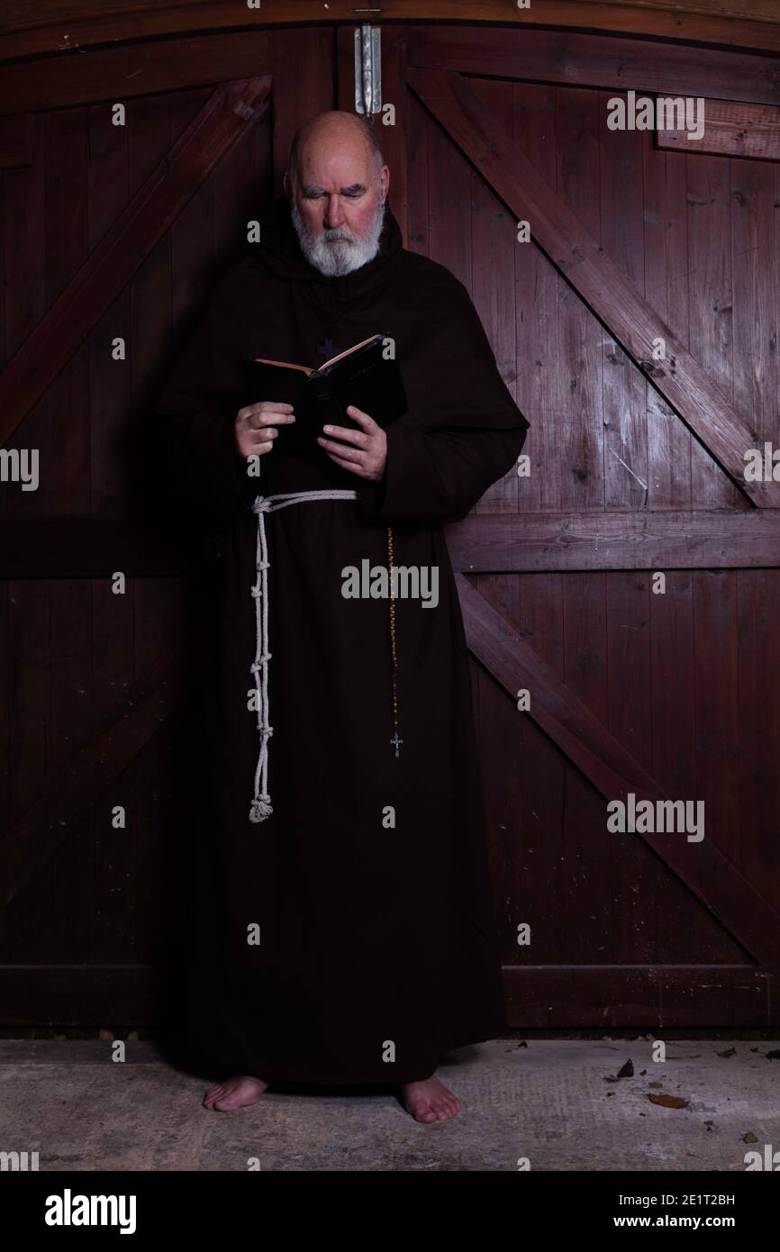 Franciscan monk, barefooted, reading his bible Stock Photo - Alamy