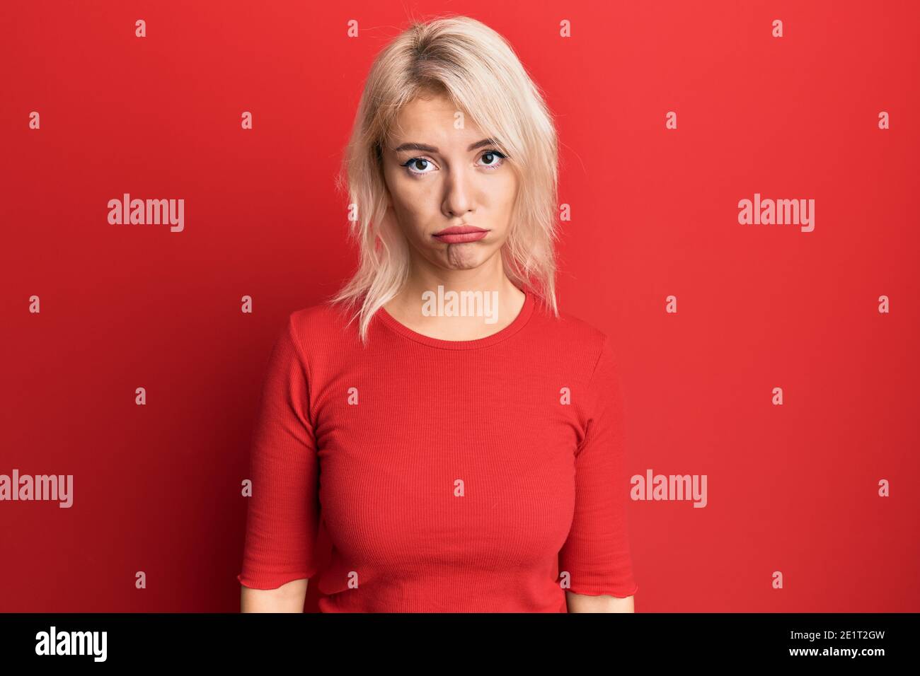 Young blonde girl wearing casual clothes depressed and worry for ...