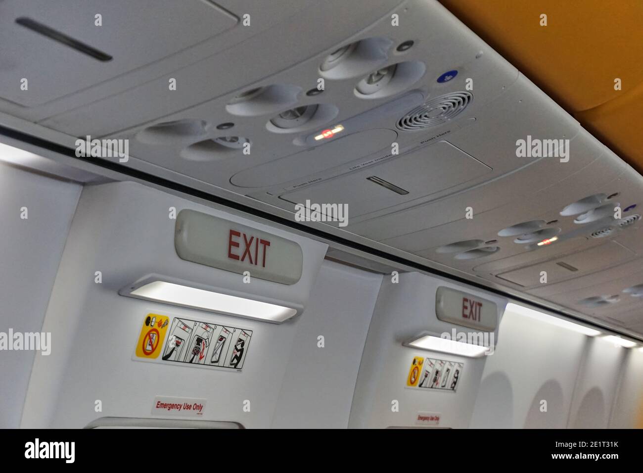 Emergency exit sign inside the airplane Stock Photo - Alamy