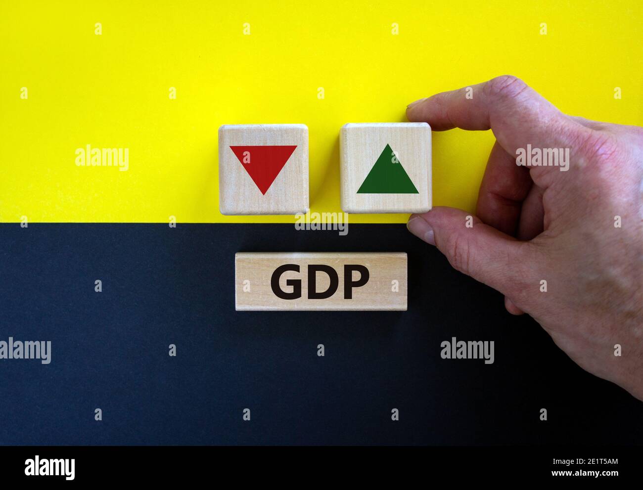 GDP, gross domestic product symbol. Businessman holds a cube with up ...