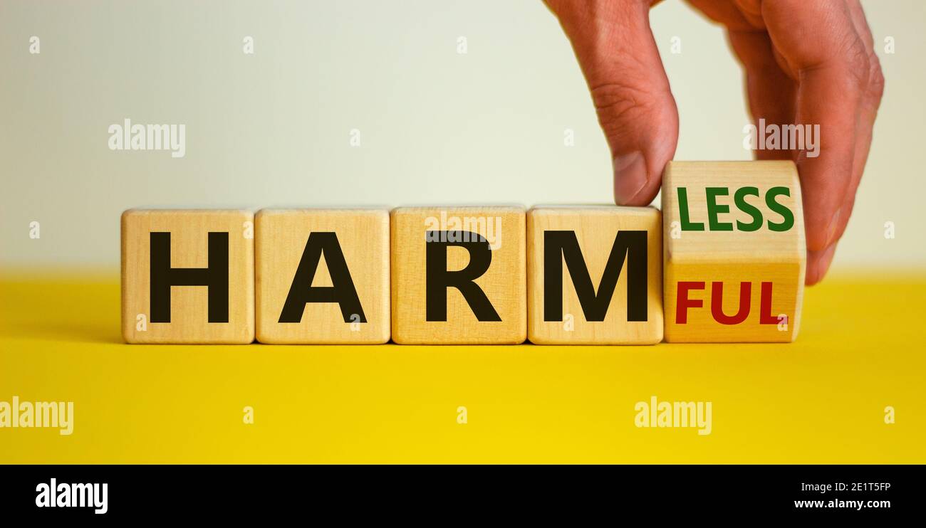 From harmful to harmless. Male hand turns the cube and changes word ...