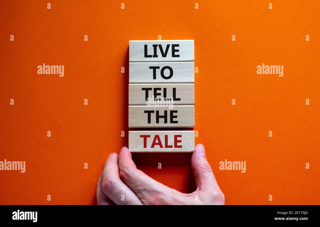Live to tell the tale symbol. Wooden blocks with words 'live to tell ...