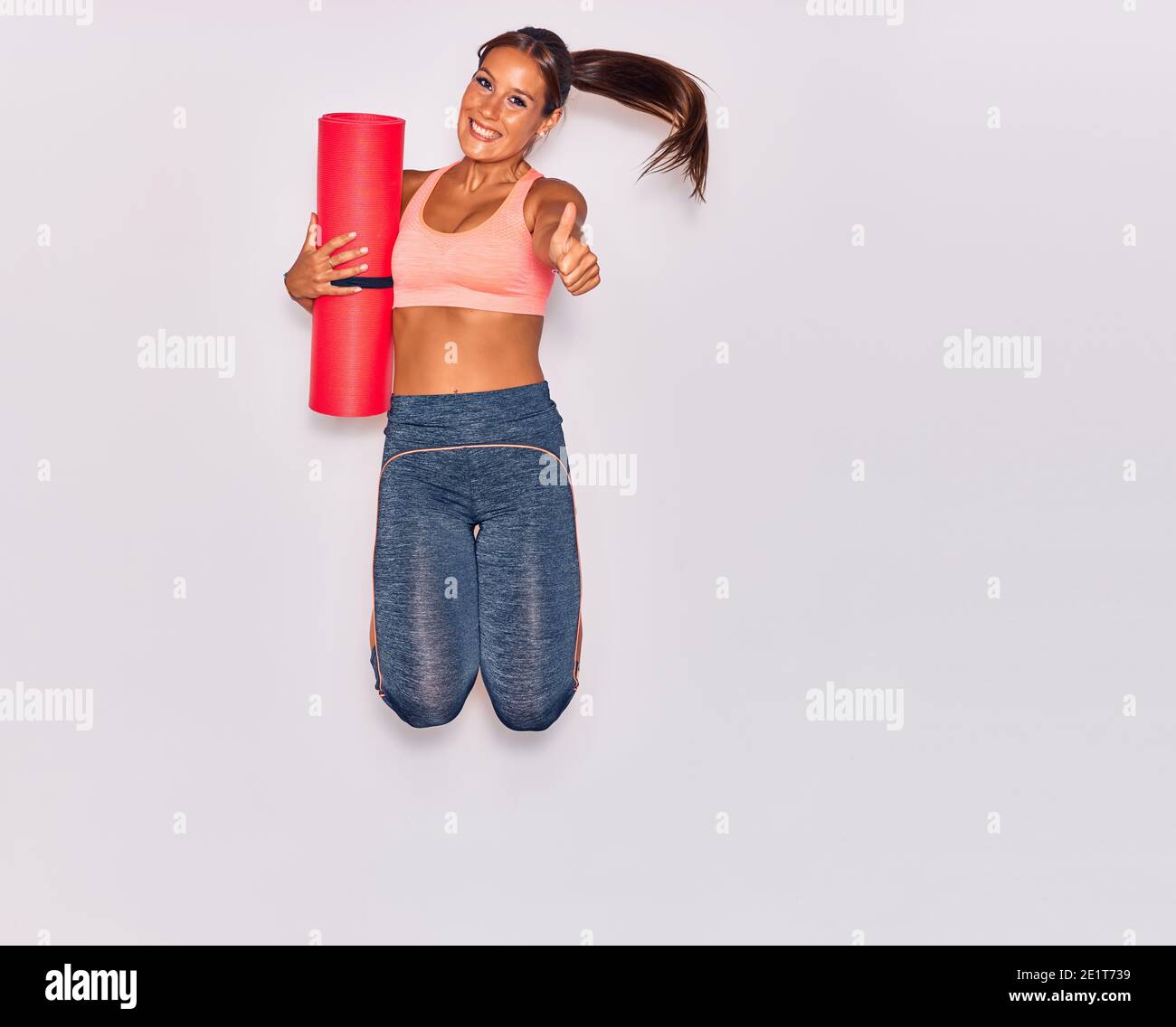 Young beautiful hispanic sportswoman wearing sporty clothes smiling ...