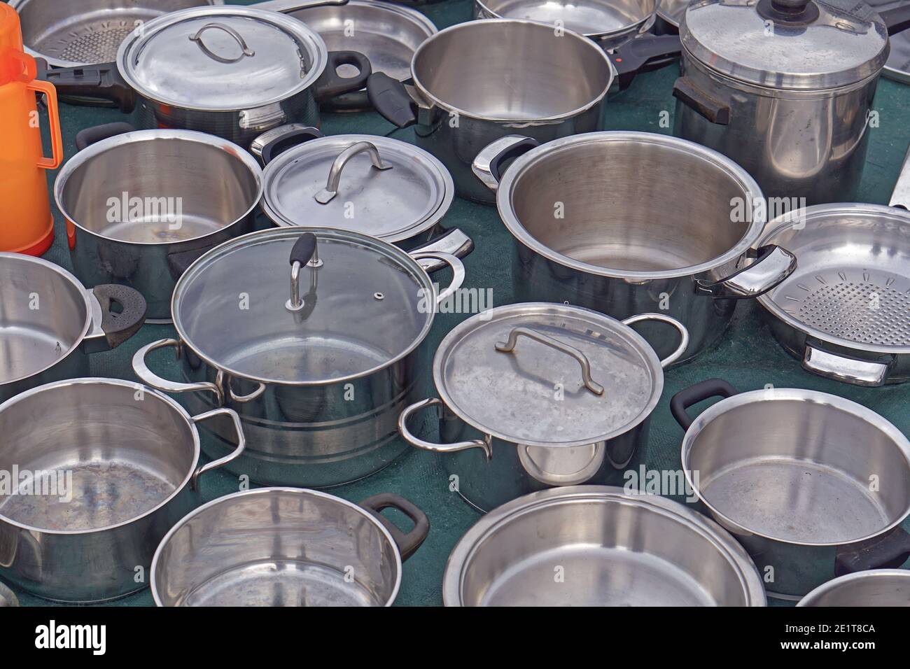 Used stainless steel metal cooking pots with lids Stock Photo - Alamy