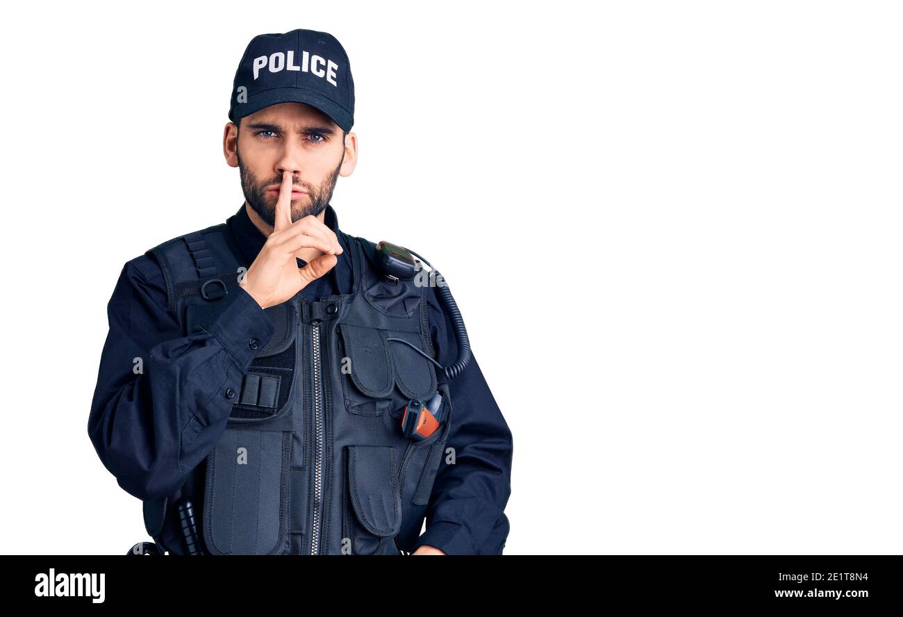 Young handsome man with beard wearing police uniform asking to be quiet ...