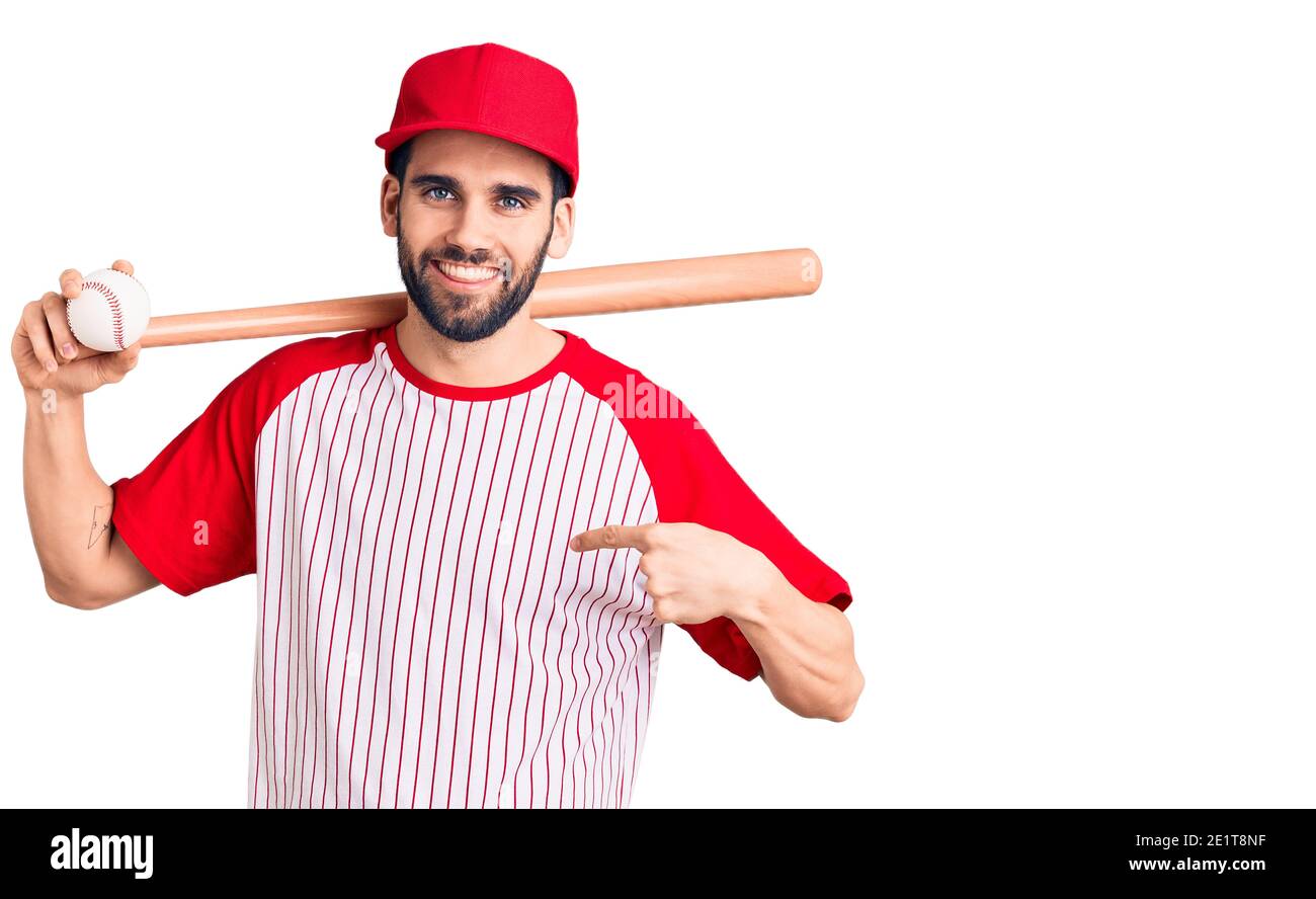 Young handsome man with beard playing baseball holding bat and ball ...