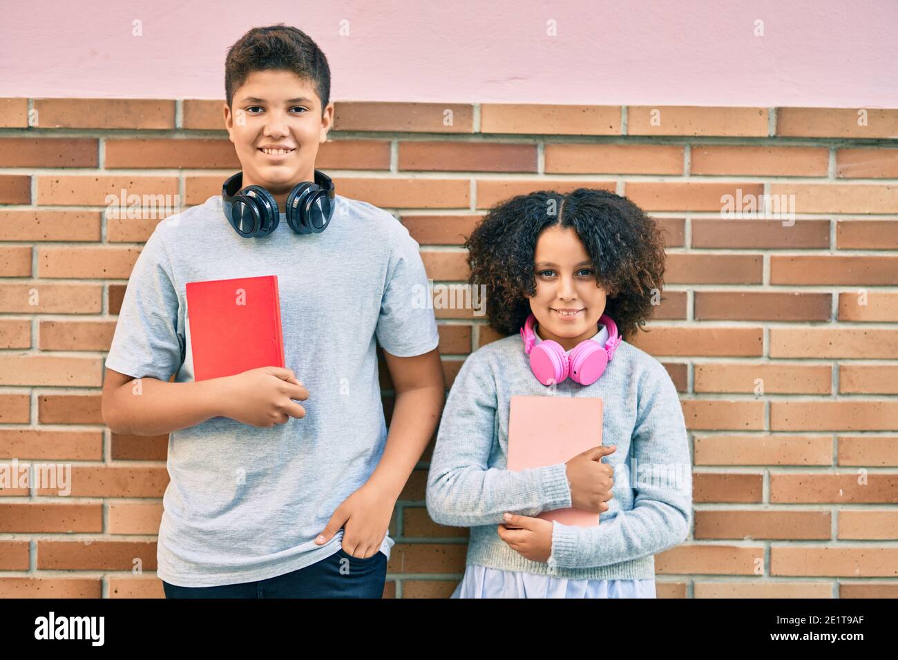 Adorable latin brother and sister smiling happy standing at the city ...