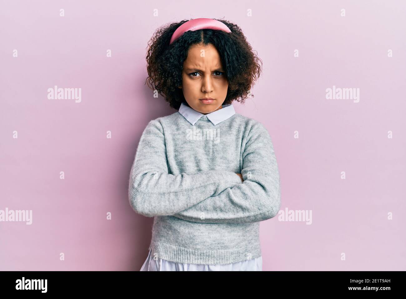 Young little girl with afro hair wearing casual clothes skeptic and ...