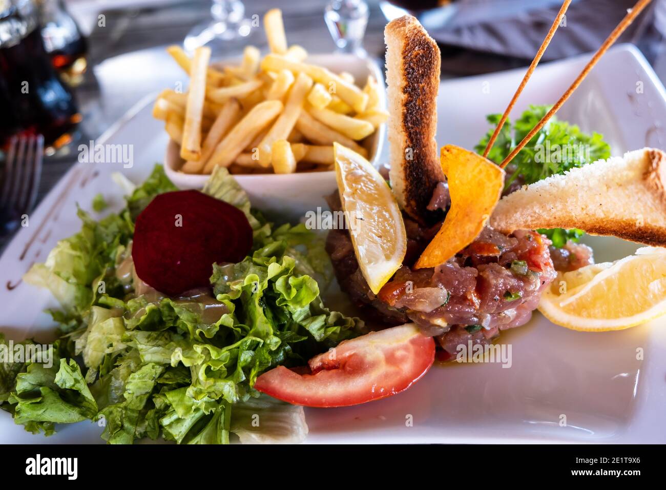 Fish tartar with french fries and salad Stock Photo - Alamy