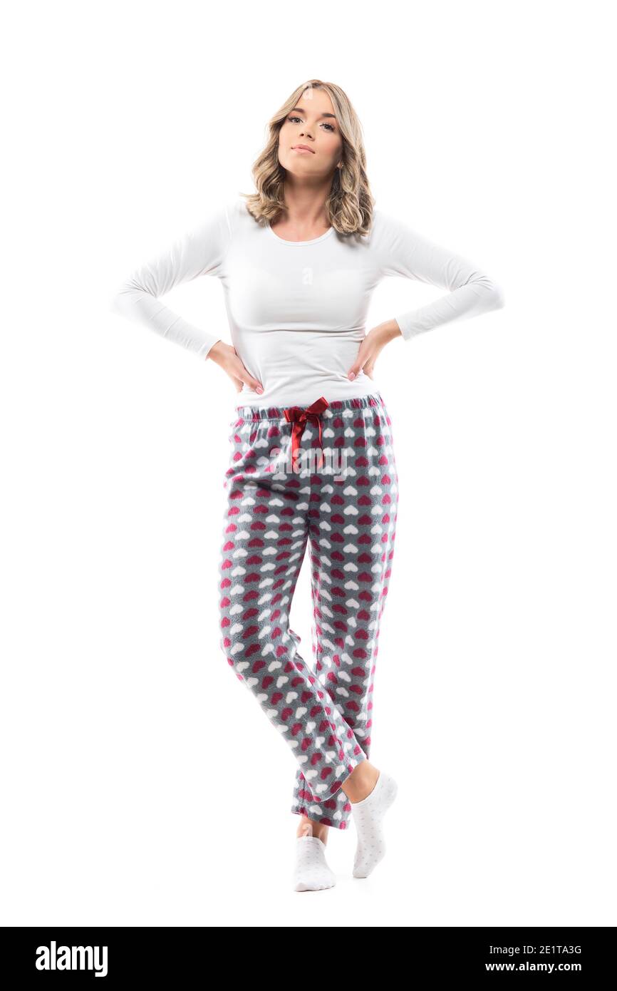 Cute confident young beauty woman in pajama with akimbo pose looking at ...