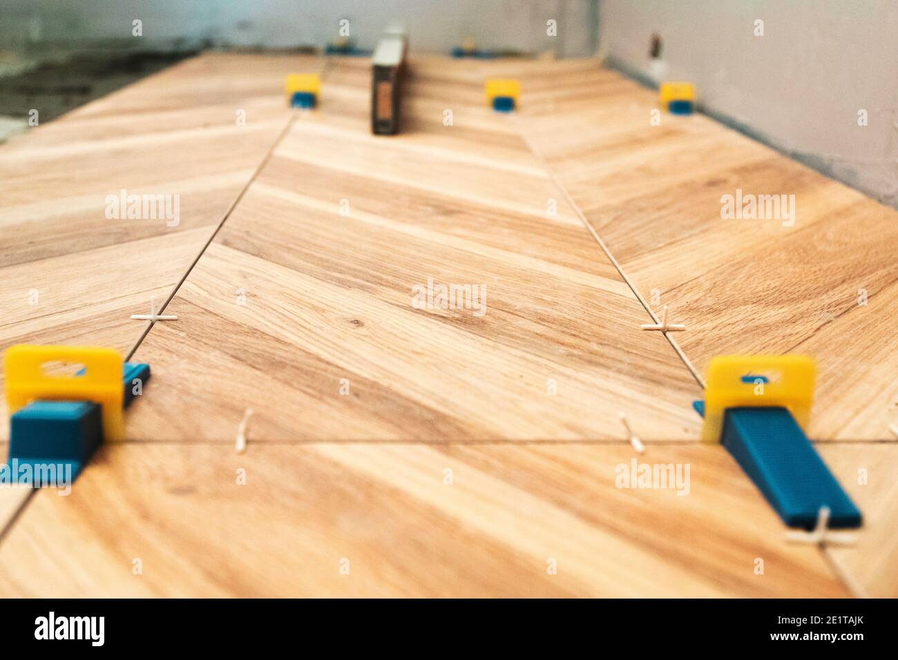 Tiling work. Layed tiles with crosses for tiles and 3d crosses. Wood ...