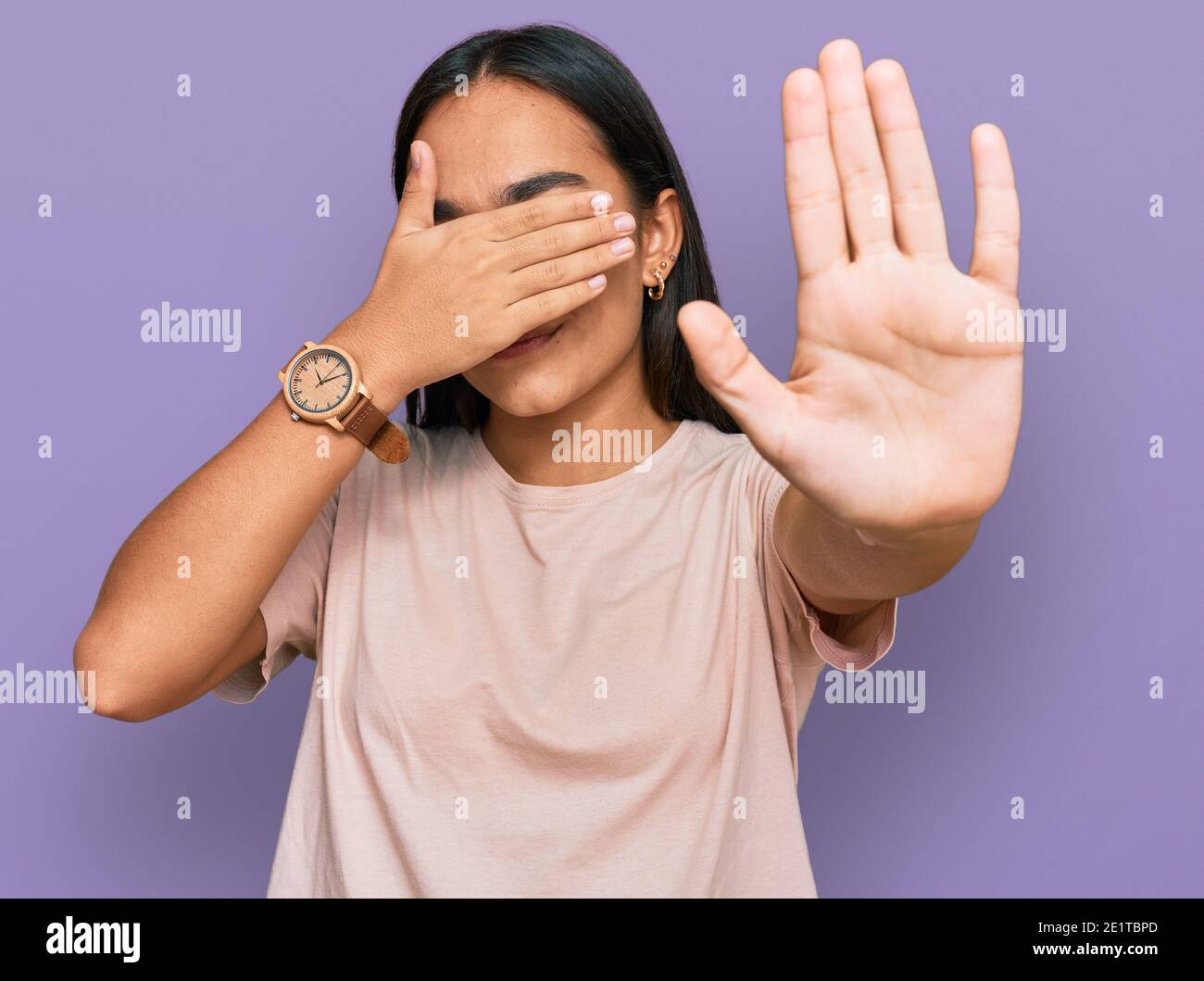 Young asian woman wearing casual clothes covering eyes with hands and ...
