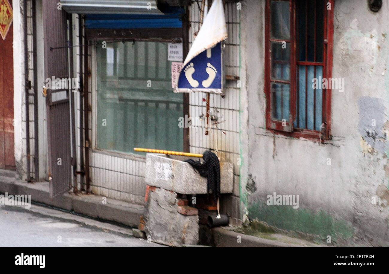 Foot massage location in a poor area of Shanghai Stock Photo - Alamy