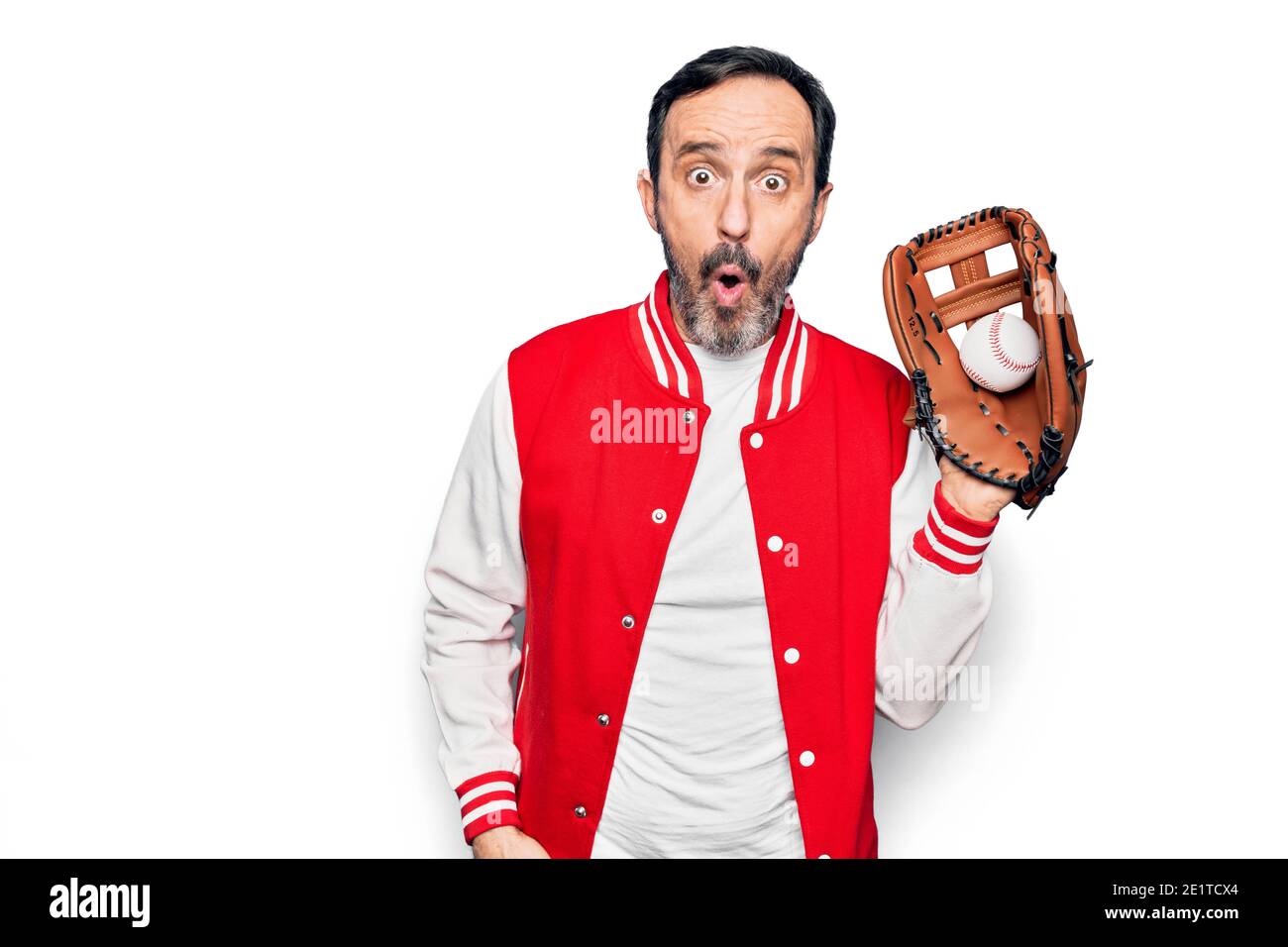 Middle age handsome sporty man wearing jacket playing baseball using ...
