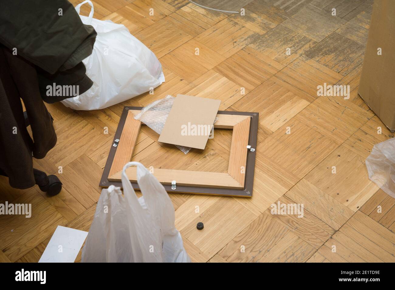 A painting with damaged frame abandoned on a floor Stock Photo - Alamy