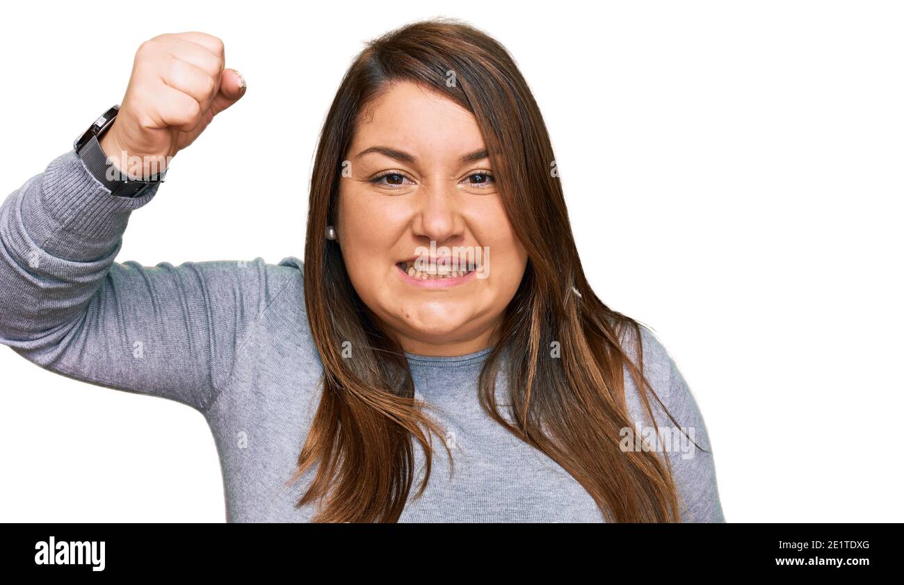 Beautiful brunette plus size woman wearing casual clothes angry and mad ...