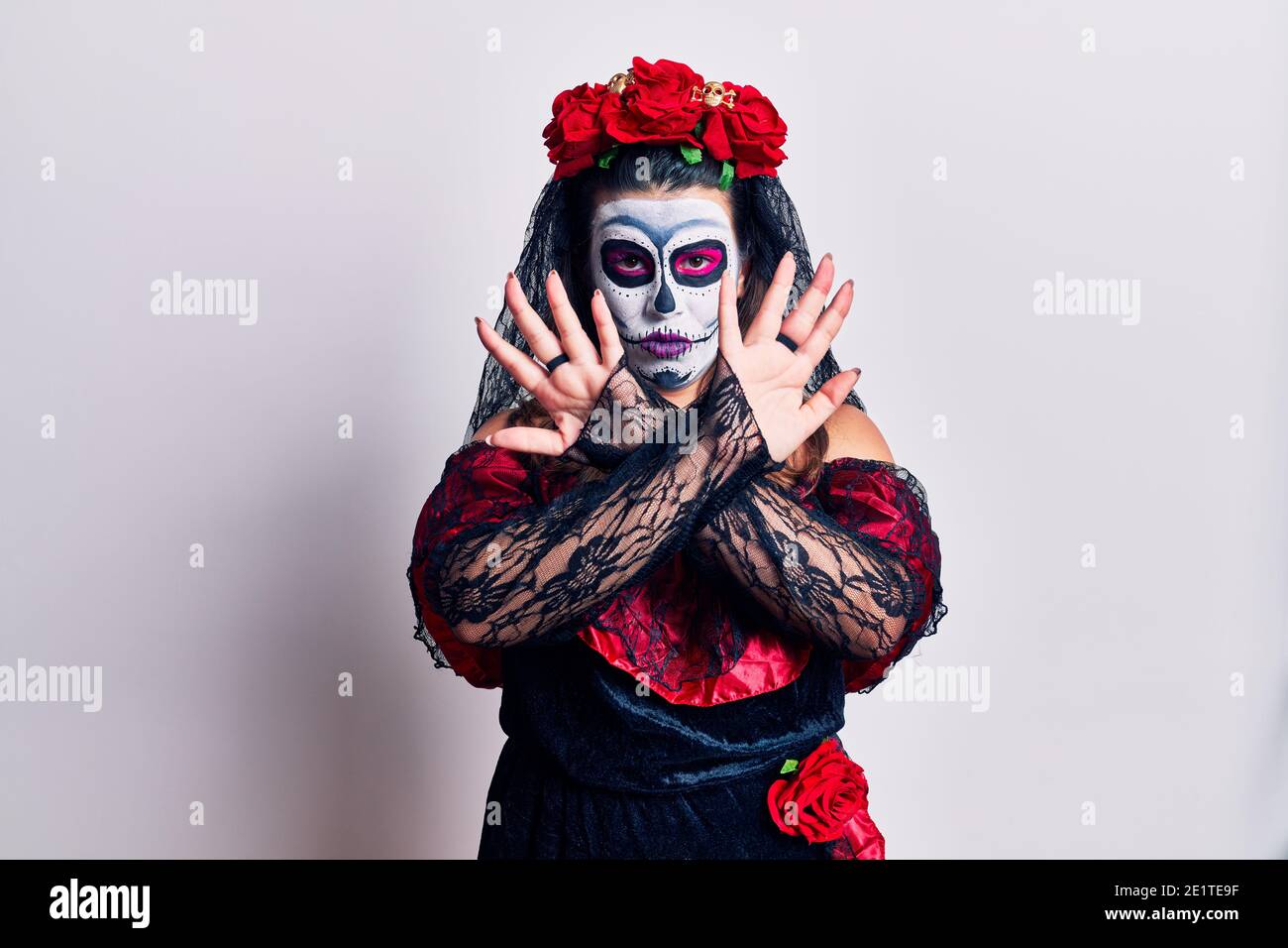 Young woman wearing day of the dead costume over white rejection ...
