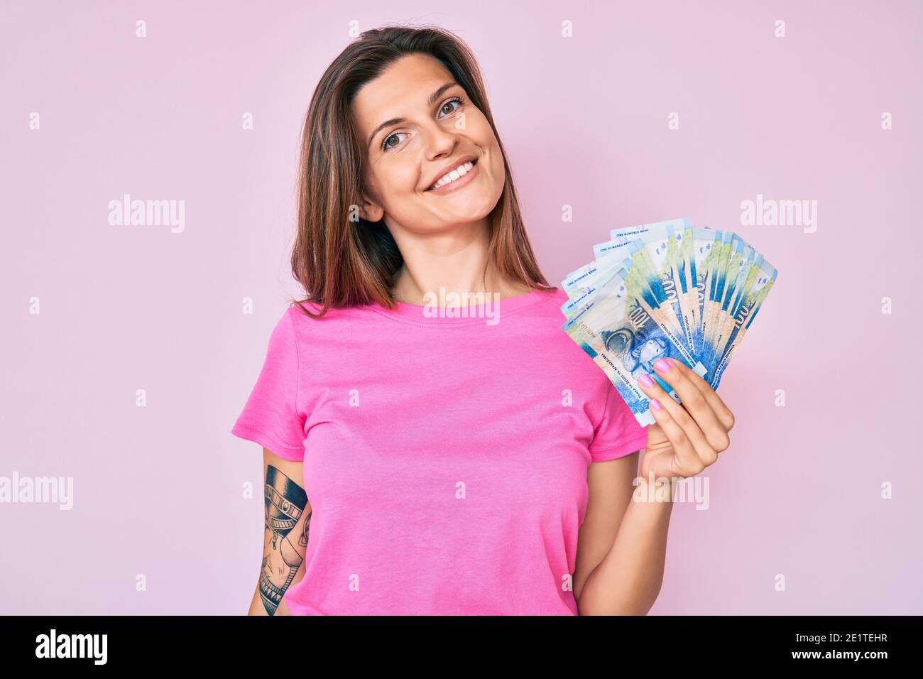 Beautiful caucasian woman holding south african rand banknotes looking ...