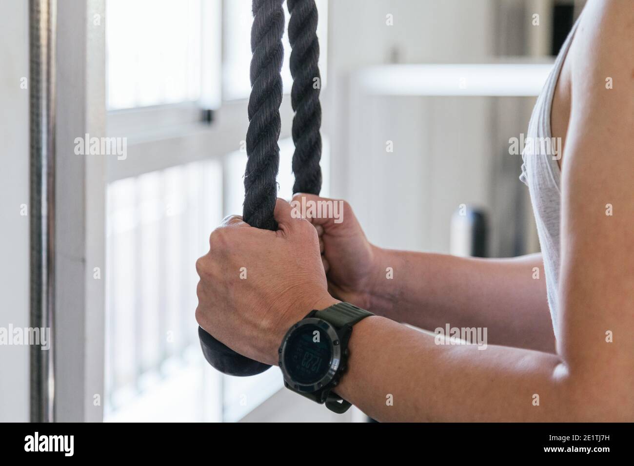 Man in a gym doing triceps with ropes.Sport and exercise concept Stock ...