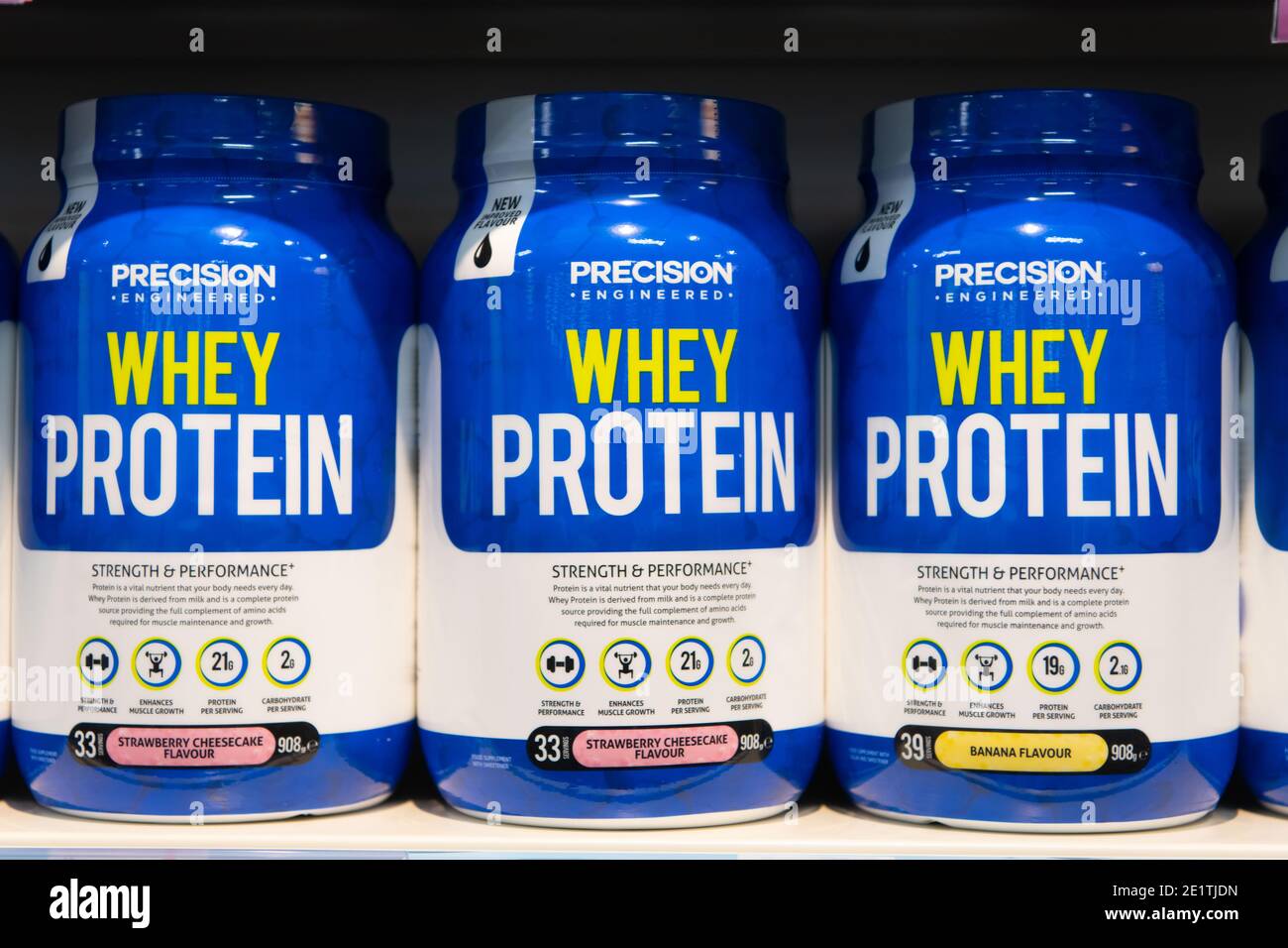 Large bottles of whey protein on sale on a shelf in a supermarket in ...