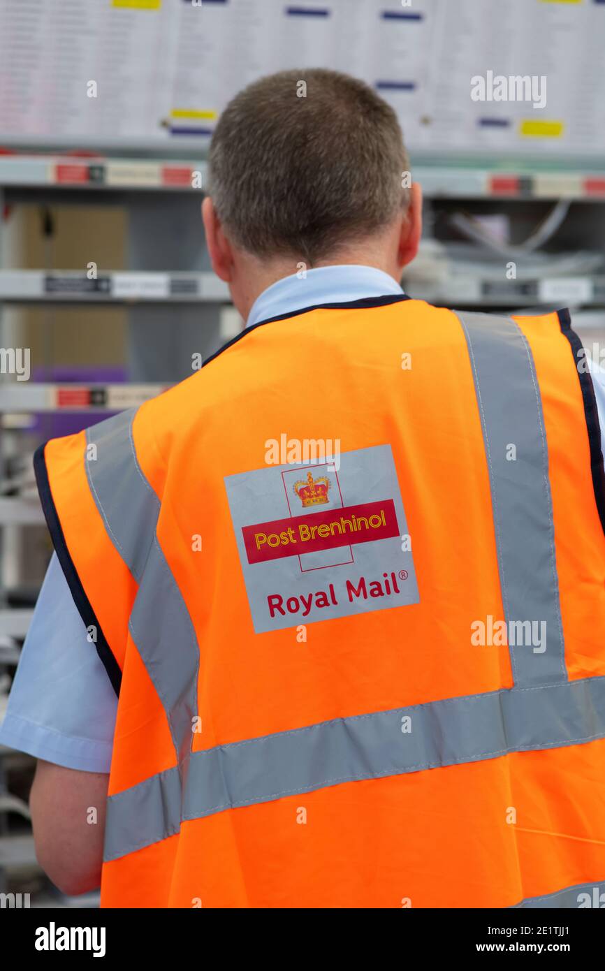 A Royal Mail worker at work in a sorting office in Cardiff, Wales ...