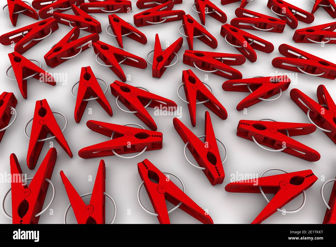 Clothespins made from plastic. Many red plastic clothespins on a white ...